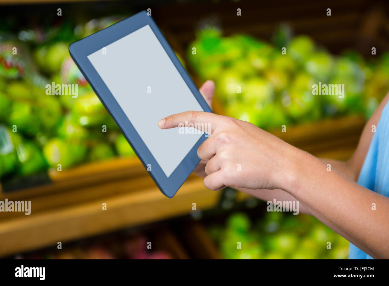 Womans hand using tablet Stock Photo - Alamy