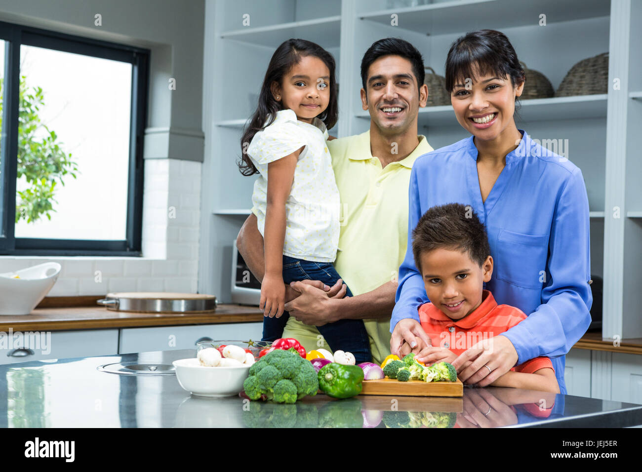 Happy family in the kitchen Stock Photo - Alamy