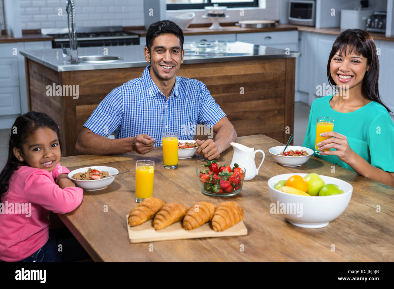 Happy family having breakfast Stock Photo - Alamy
