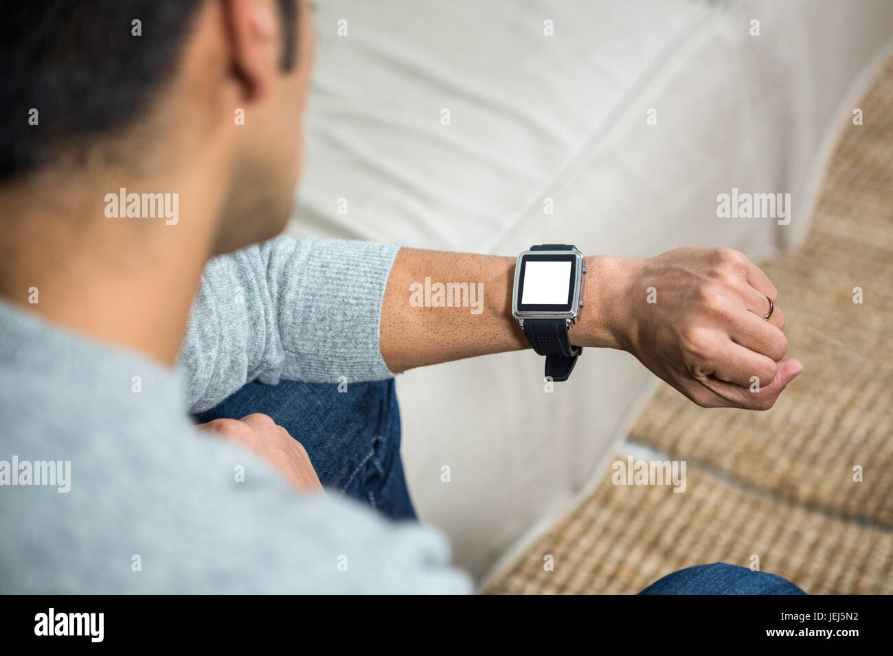 Handsome man using smartwatch Stock Photo - Alamy