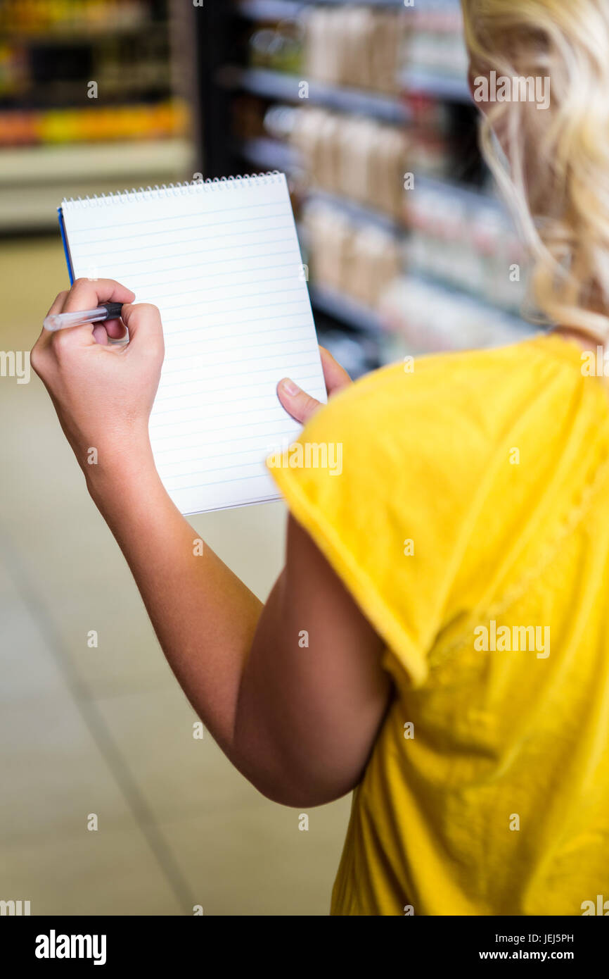 Cropped image of woman checking list Stock Photo - Alamy