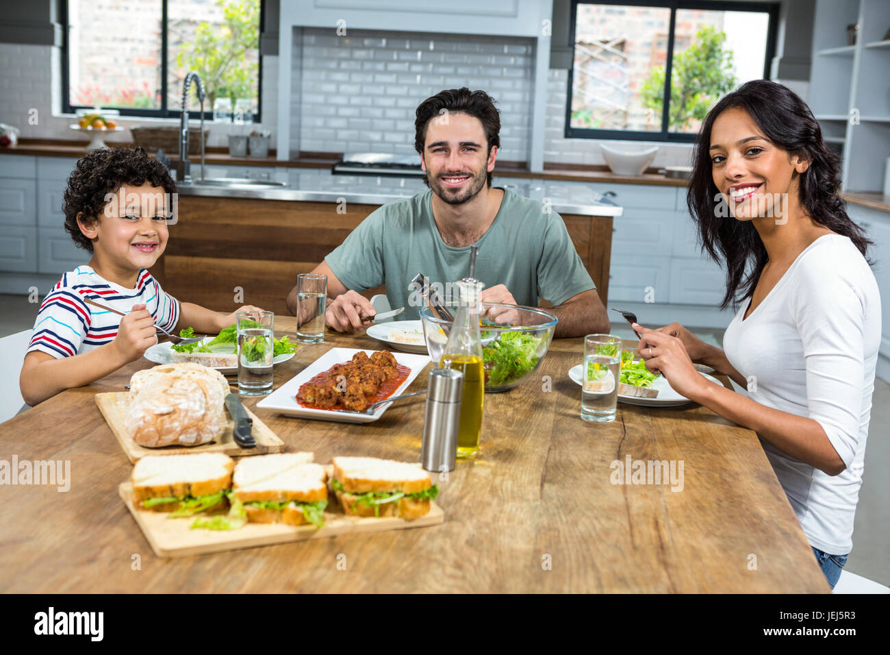 Happy family having lunch together Stock Photo - Alamy