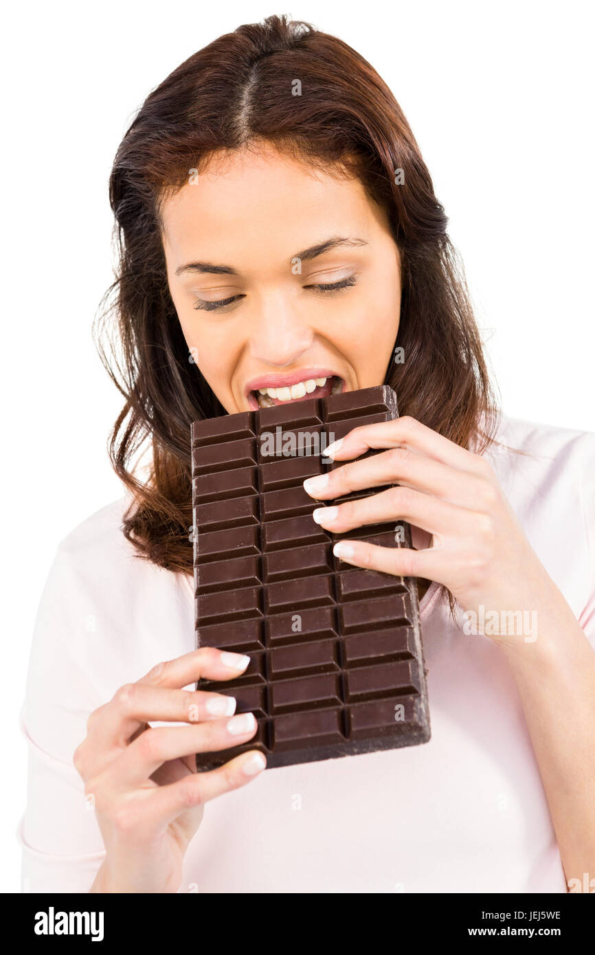Casual woman crunching bar of chocolate Stock Photo - Alamy
