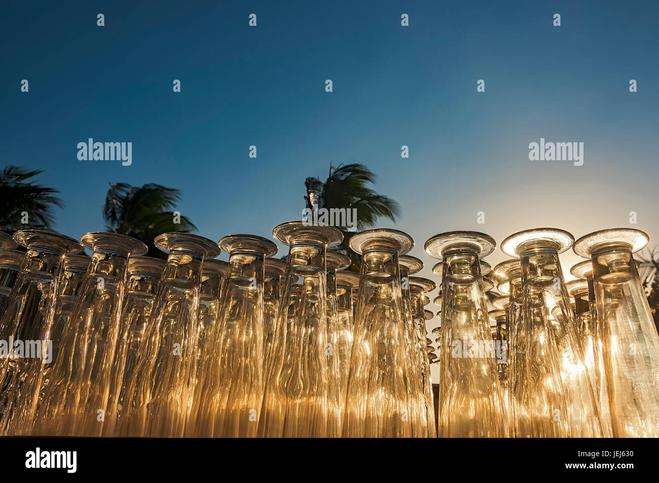 Stack of tall glasses in a summer garden setting Stock Photo - Alamy