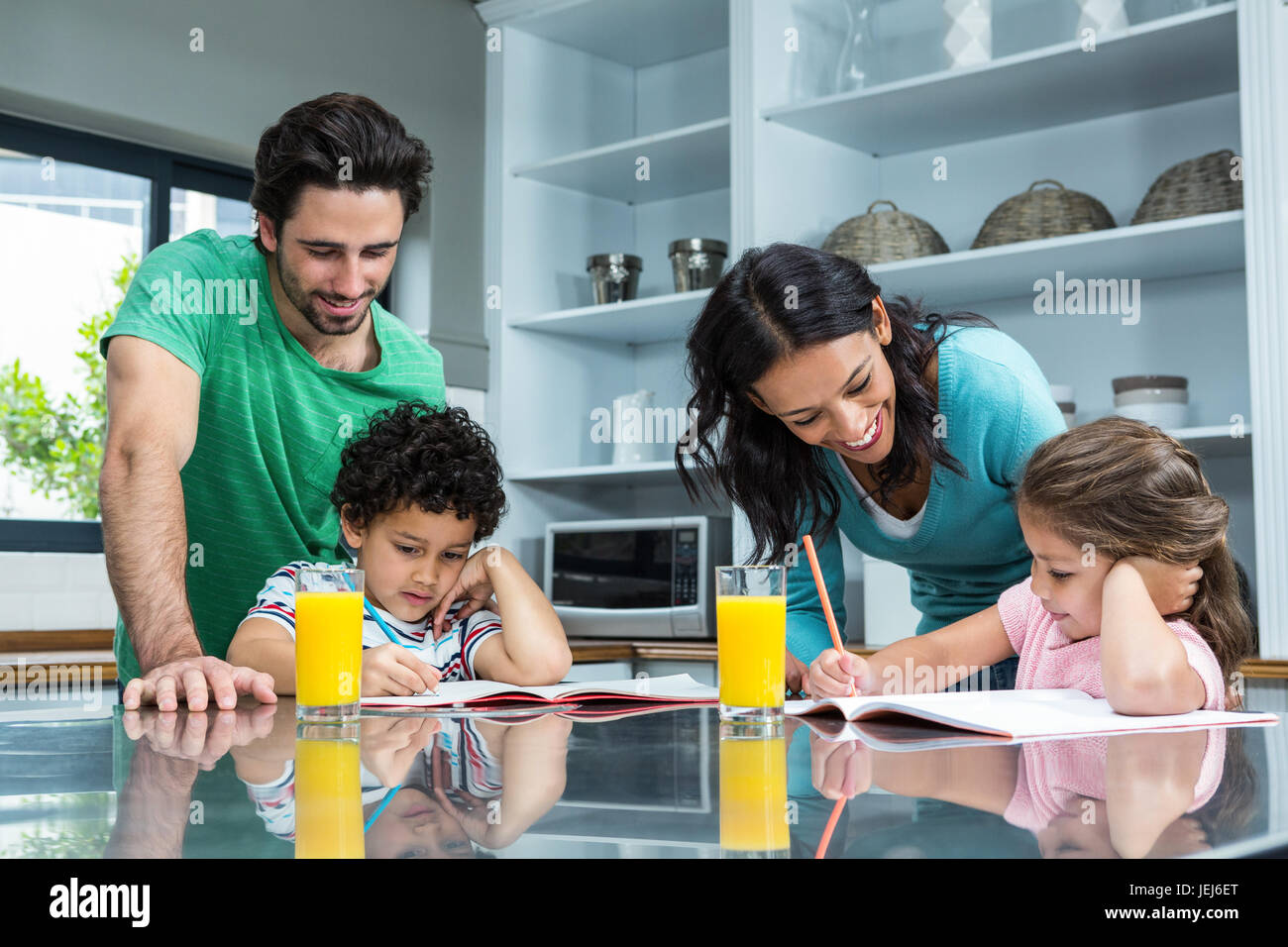 Parents helping their children doing homework Stock Photo - Alamy