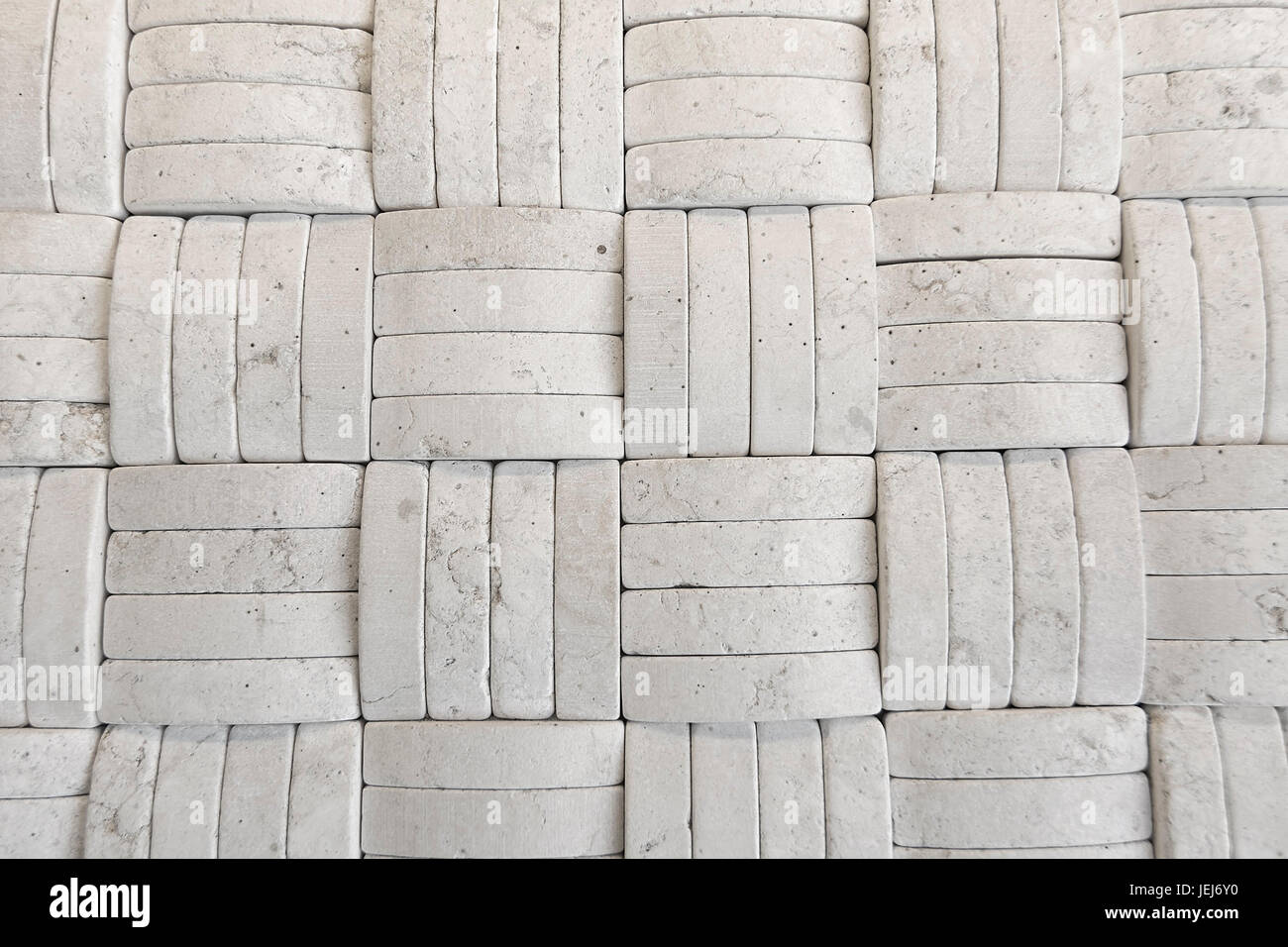 Textured, weaved stone wall design Stock Photo - Alamy