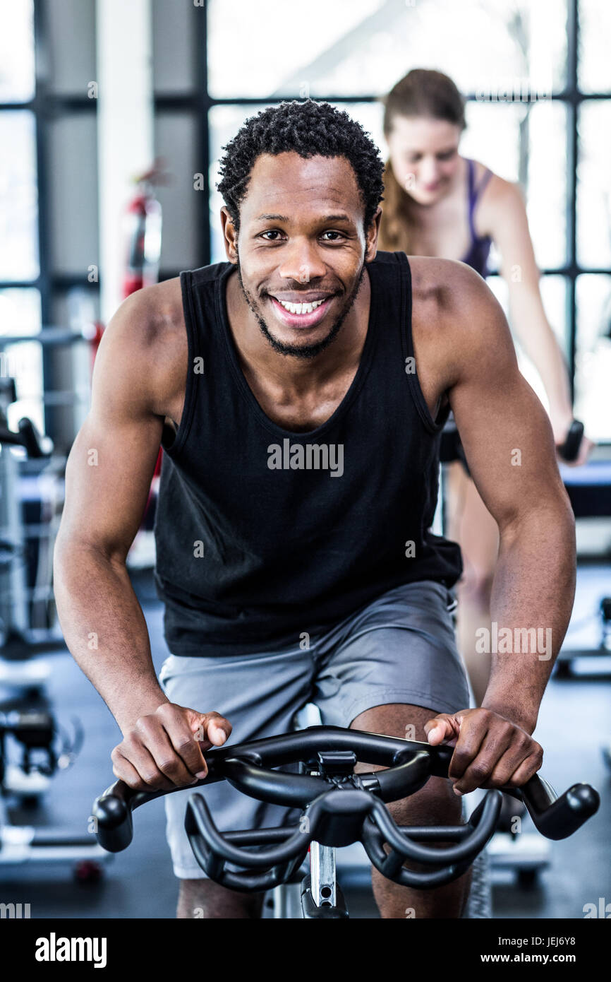 Fit man working out at spinning class Stock Photo - Alamy