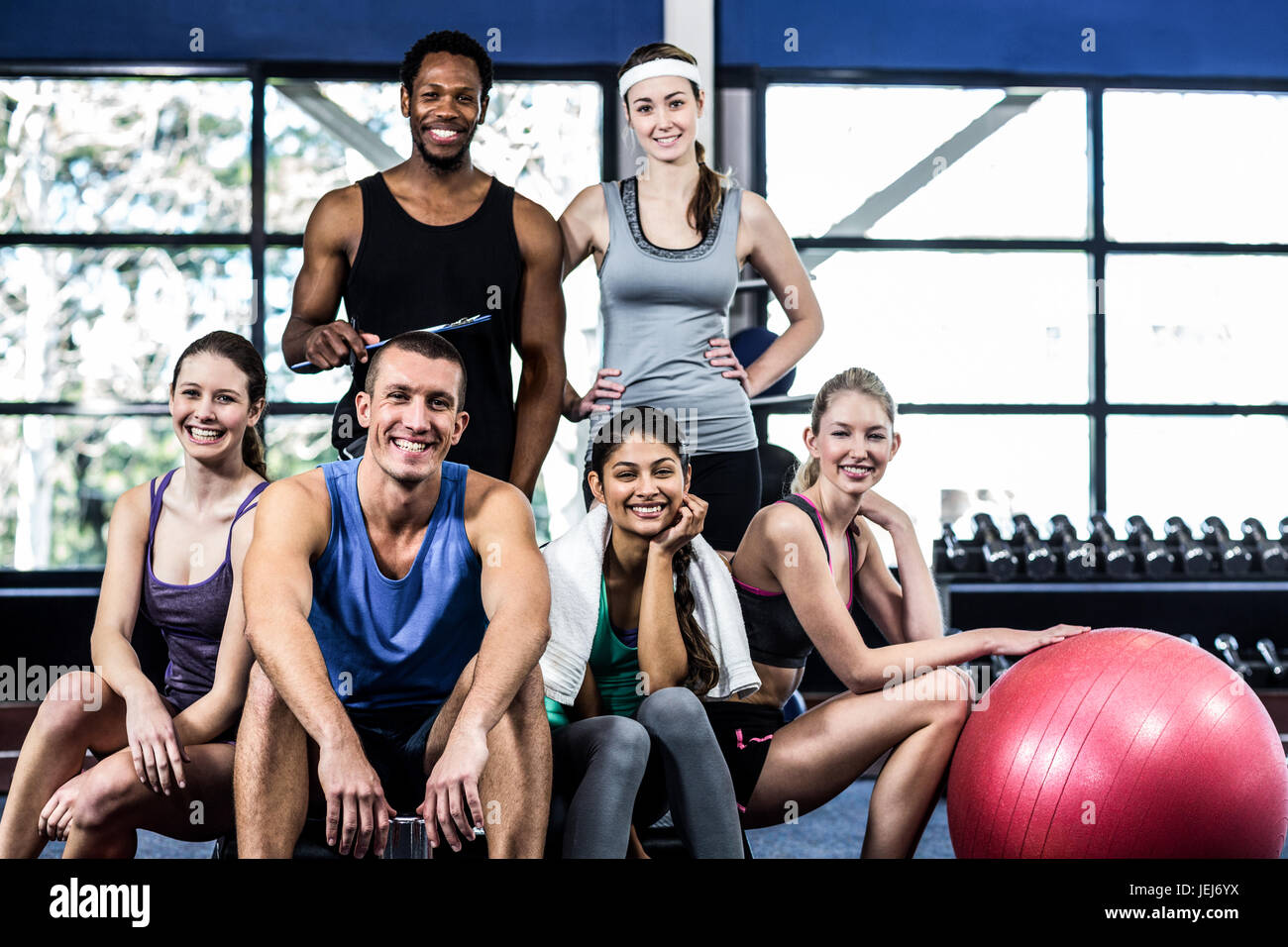 Smiling fitness class posing together Stock Photo - Alamy