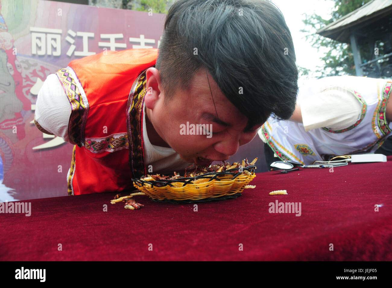 Lijian, Lijian, China. 25th June, 2017. A participant eats insects at ...