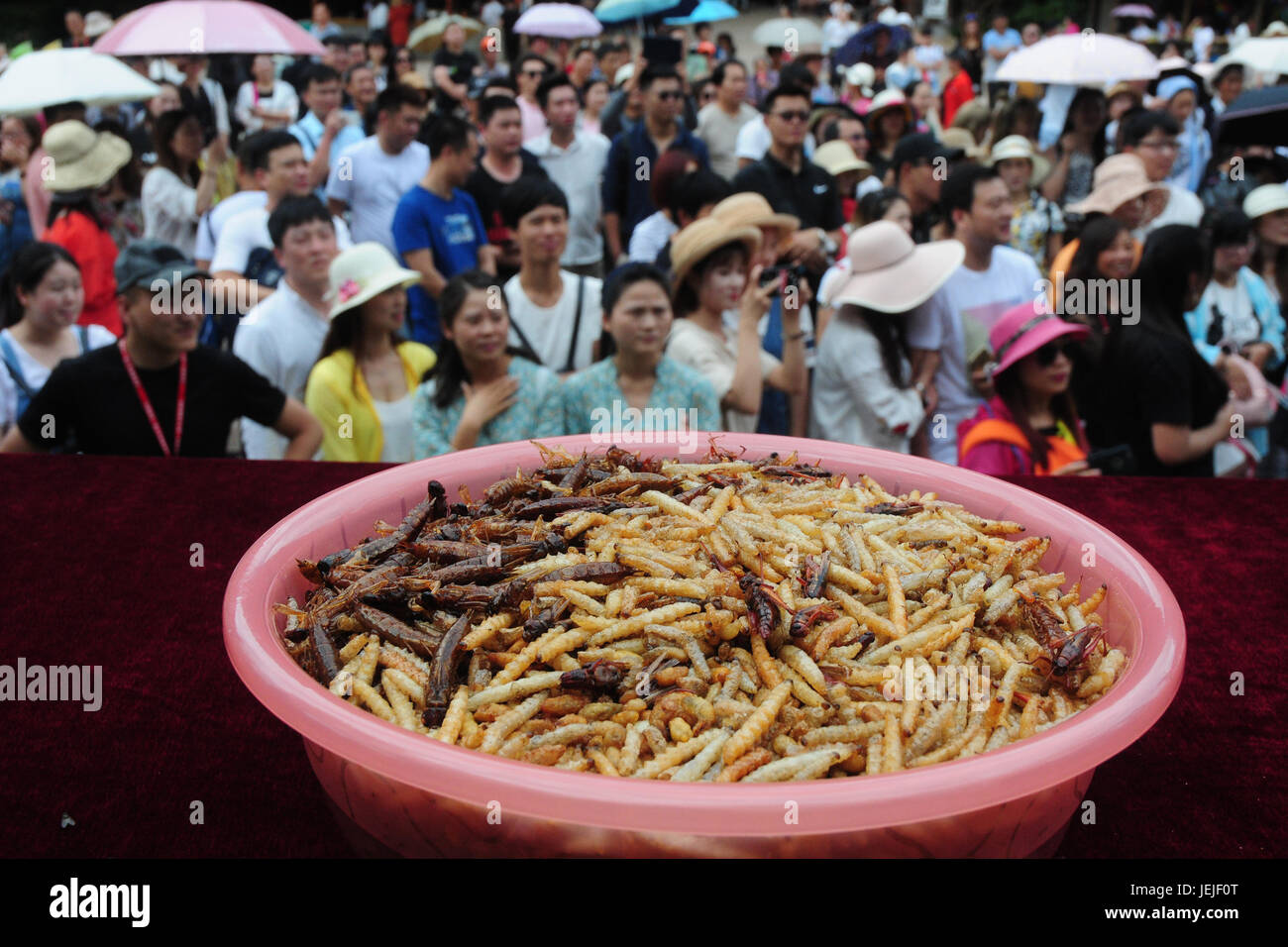 Lijian, Lijian, China. 25th June, 2017. A participant eats insects at ...