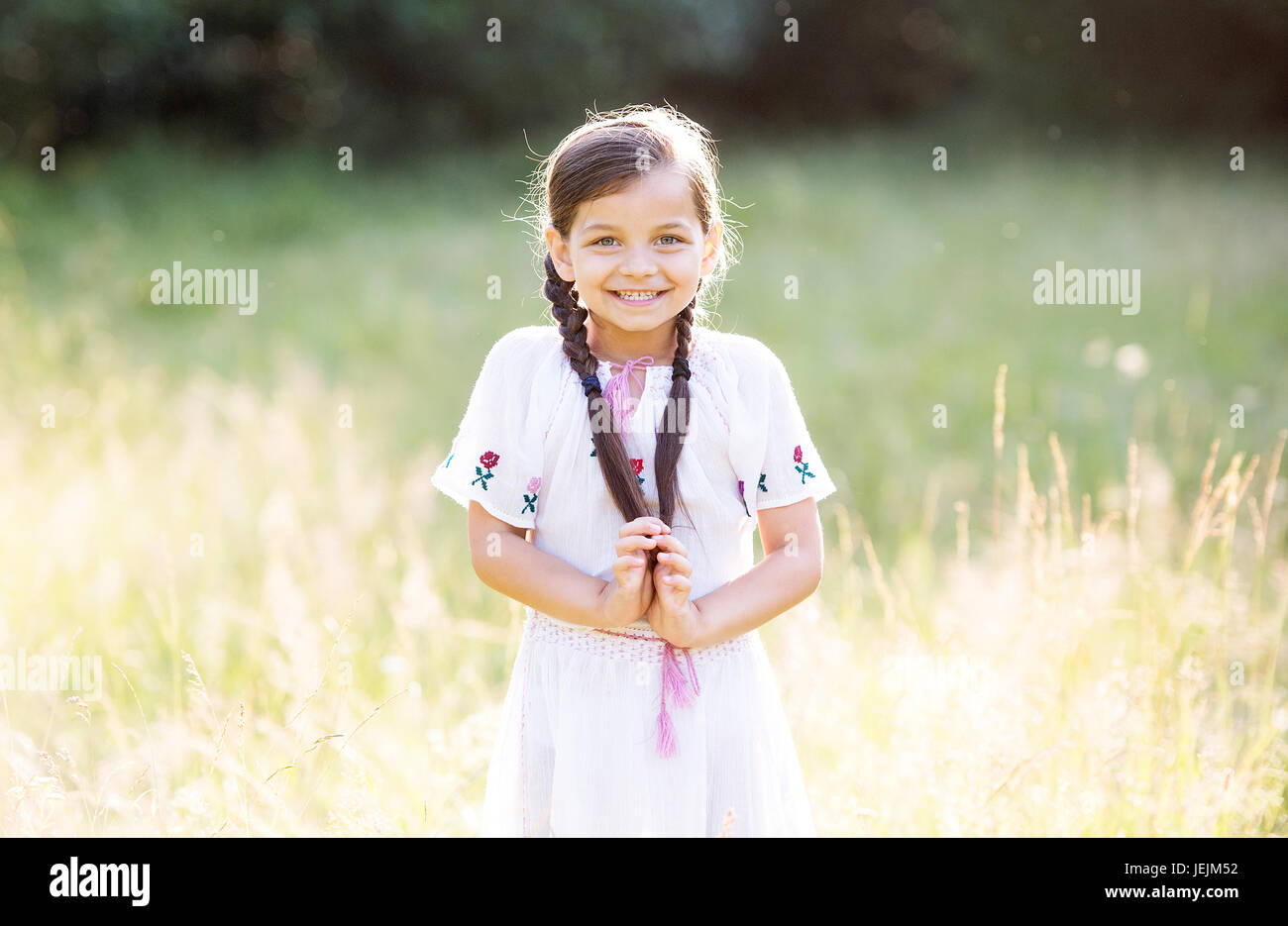 little happy girl with tight braids wearing traditional romanian blouse ...