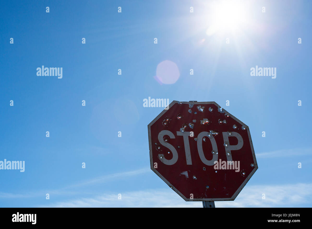 Stop sign with holes from bullets Stock Photo - Alamy
