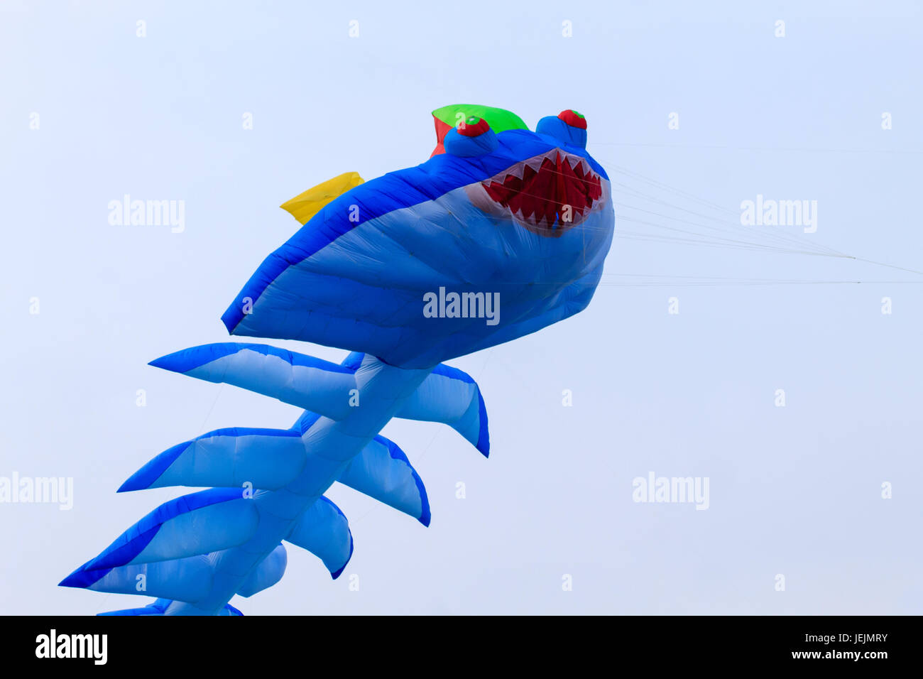 Blue kite that is flying. Blue fish kite Stock Photo - Alamy