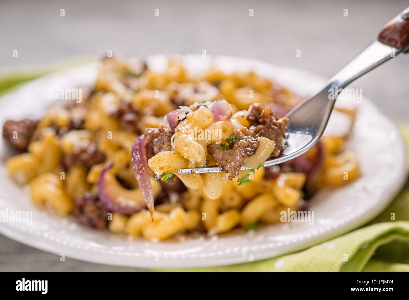 tasty cellentani pasta with meat sauce and onion Stock Photo - Alamy