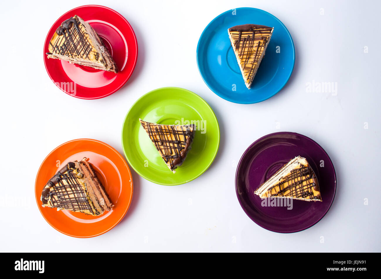 Caramel cake slices served on colorful plates Stock Photo - Alamy