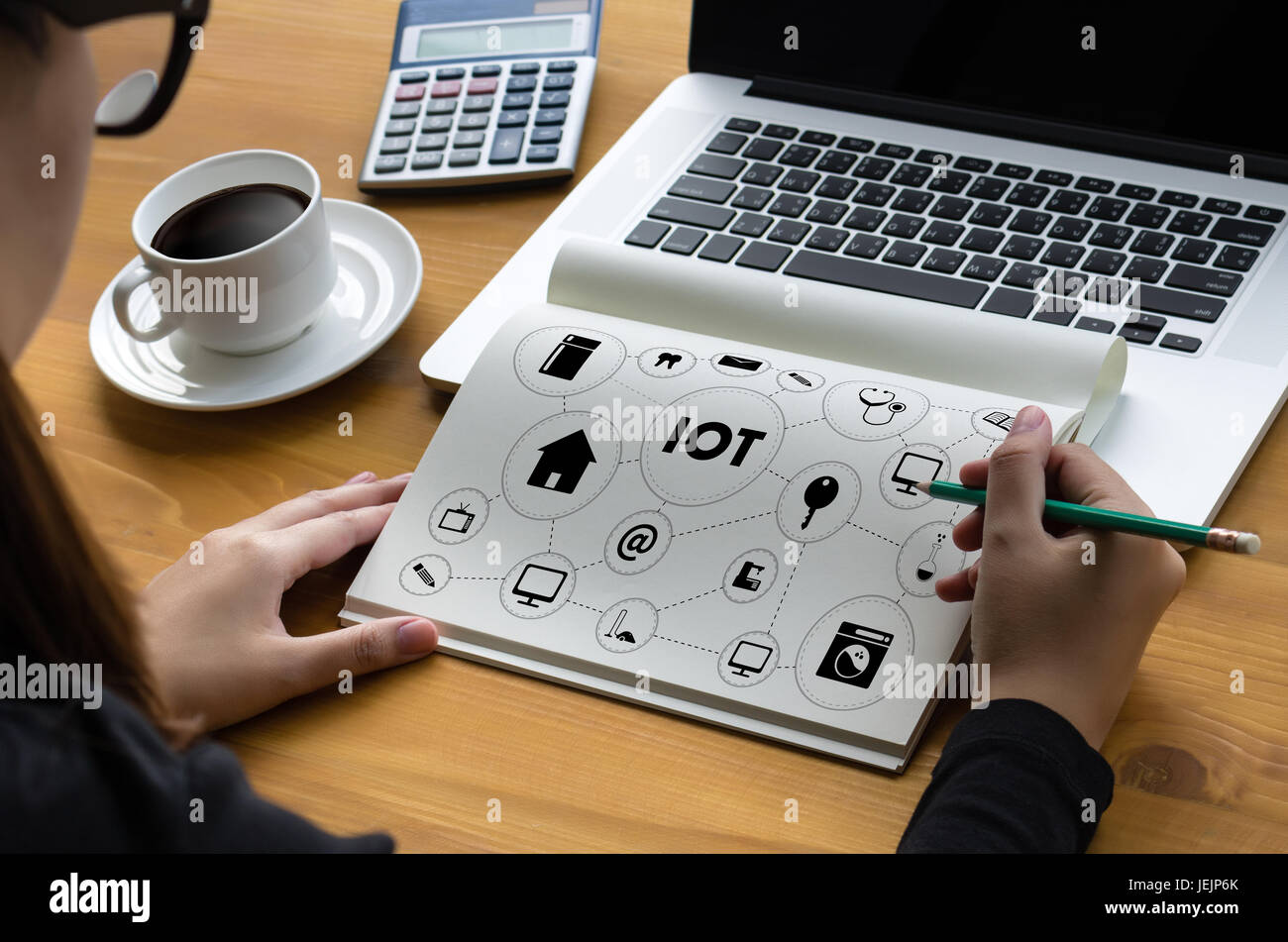 IOT business man hand working and internet of things (IoT) word diagram ...
