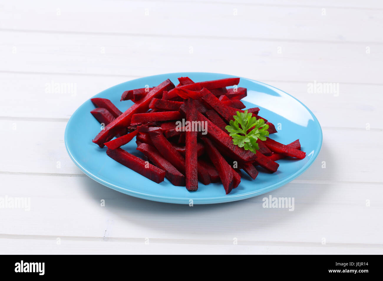 plate of beetroot strips on white wooden background Stock Photo - Alamy