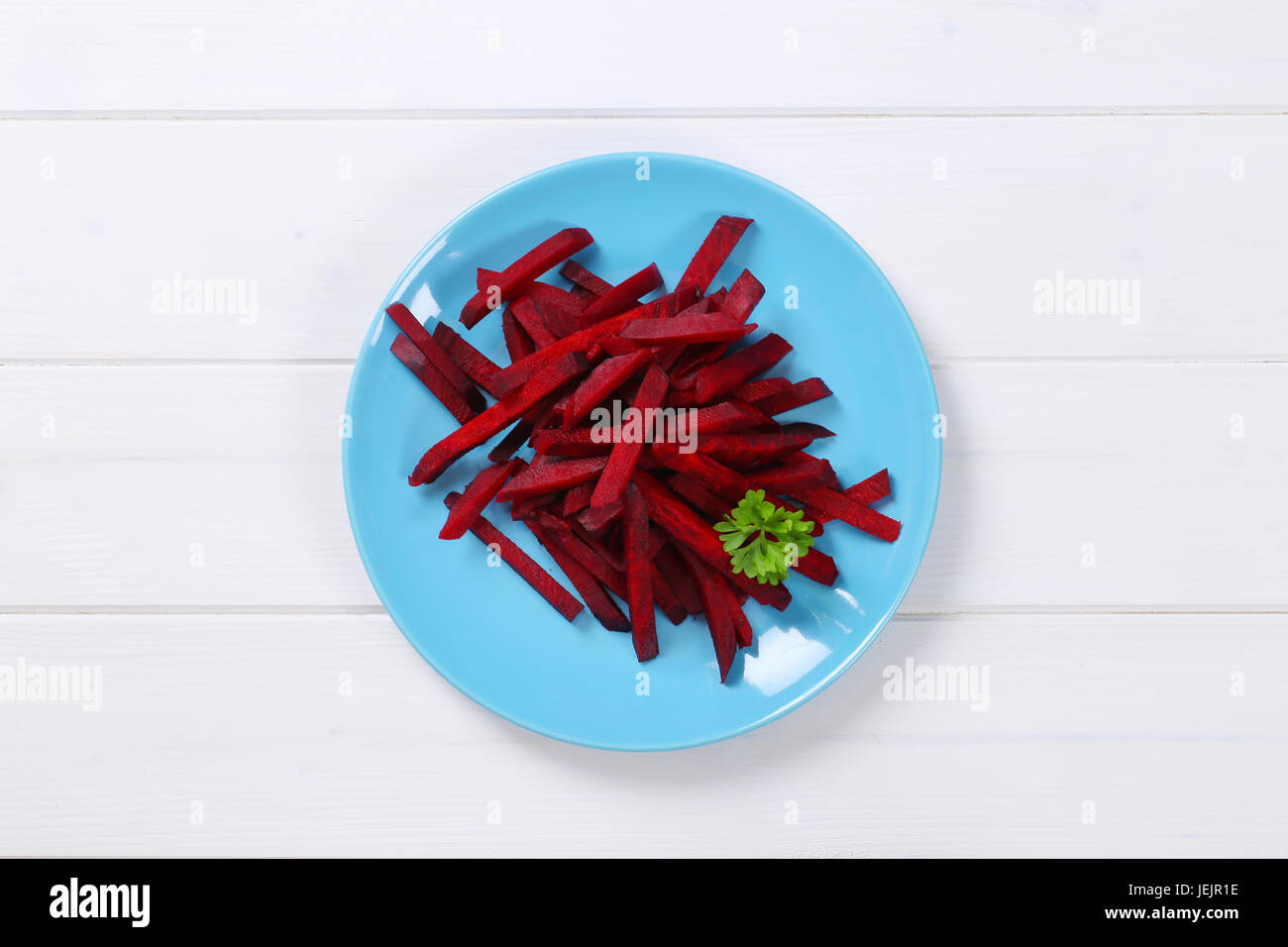 plate of beetroot strips on white wooden background Stock Photo - Alamy