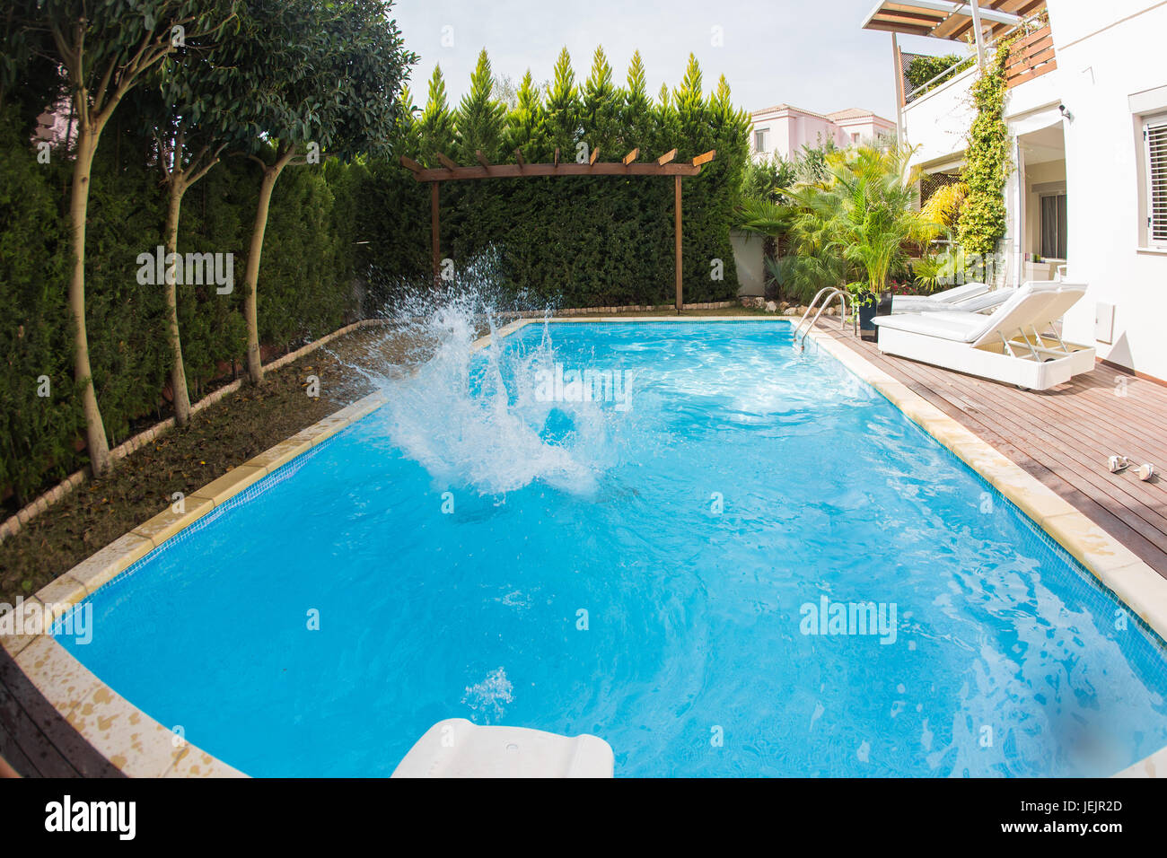 Splashing water in pool Stock Photo - Alamy