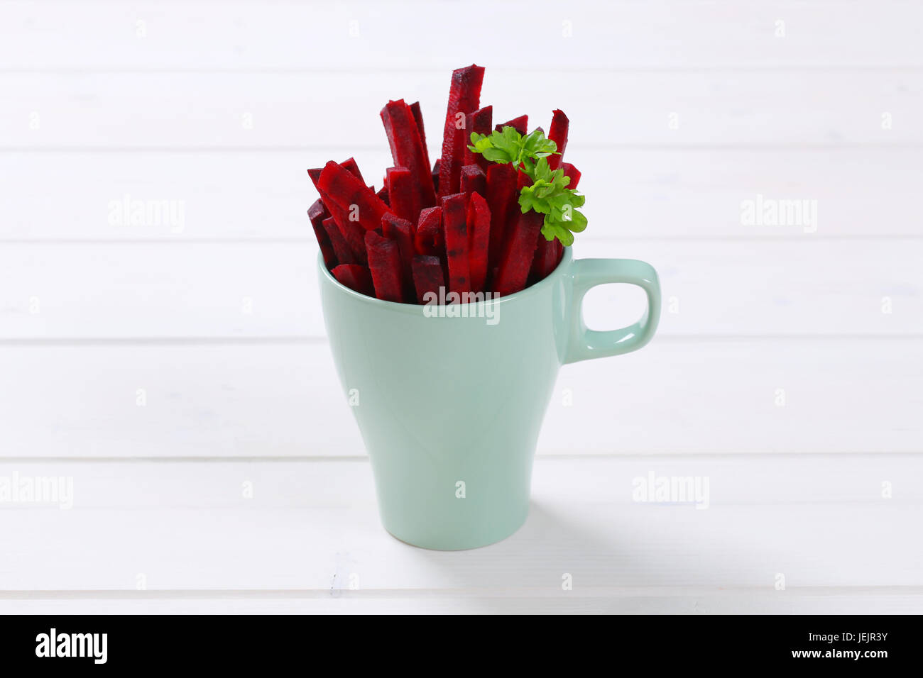 cup of beetroot strips on white wooden background Stock Photo - Alamy
