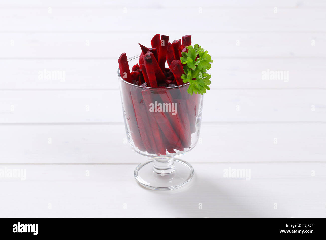 glass of beetroot strips on white wooden background Stock Photo - Alamy