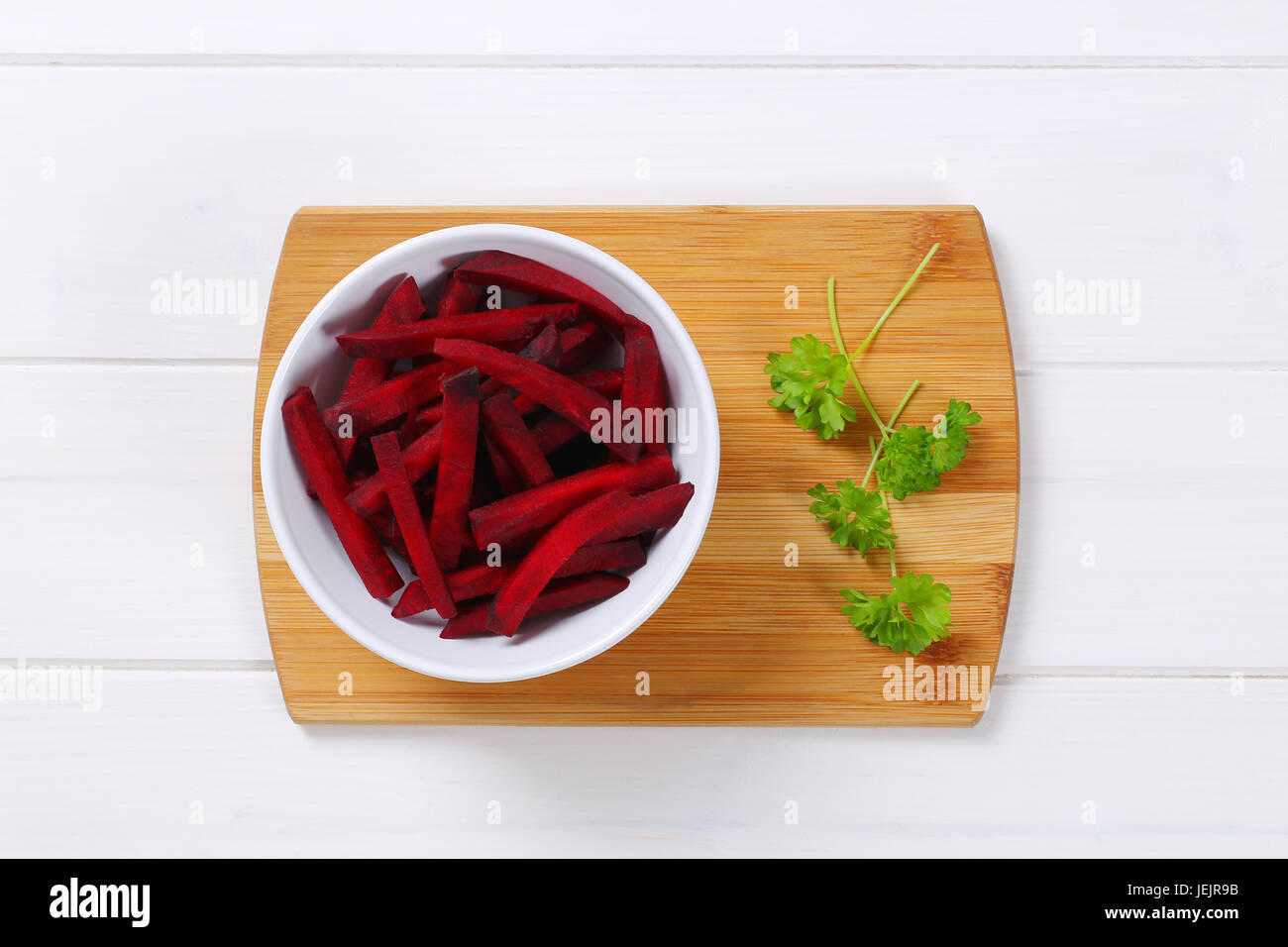 bowl of beetroot strips on wooden cutting board Stock Photo - Alamy