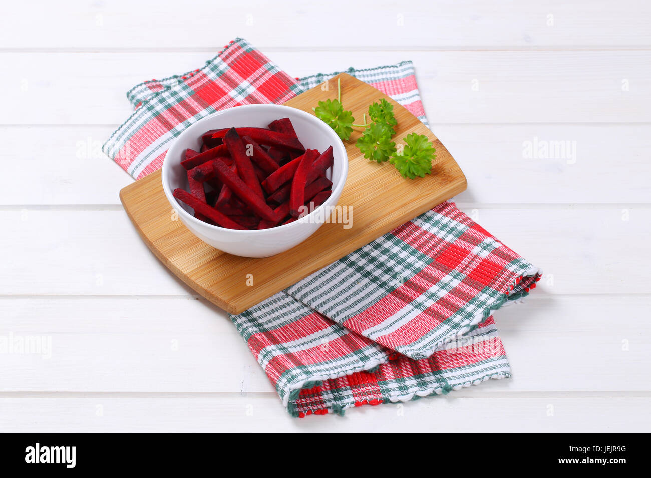 bowl of beetroot strips on wooden cutting board Stock Photo - Alamy