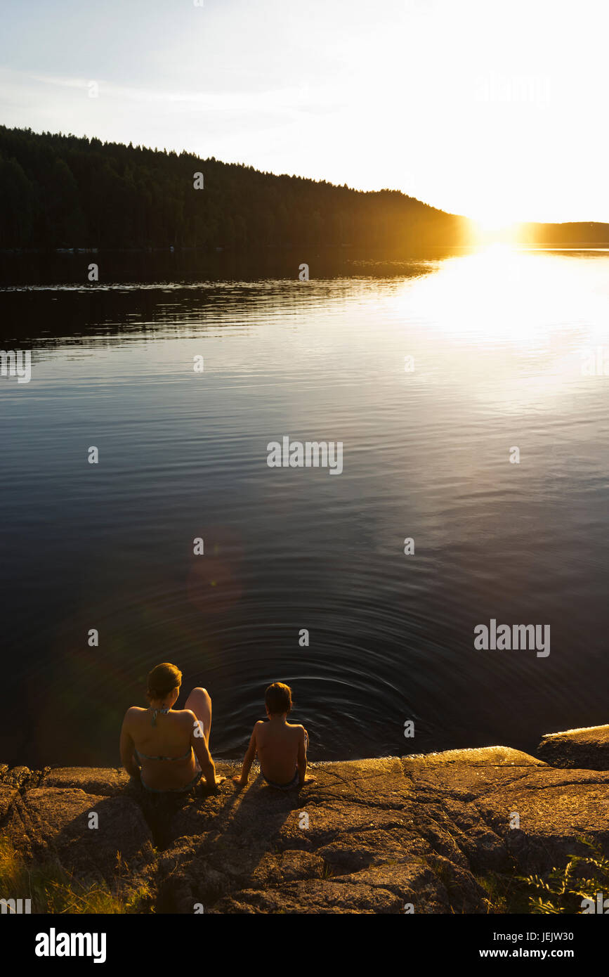 Woman with son looking at sunset Stock Photo - Alamy