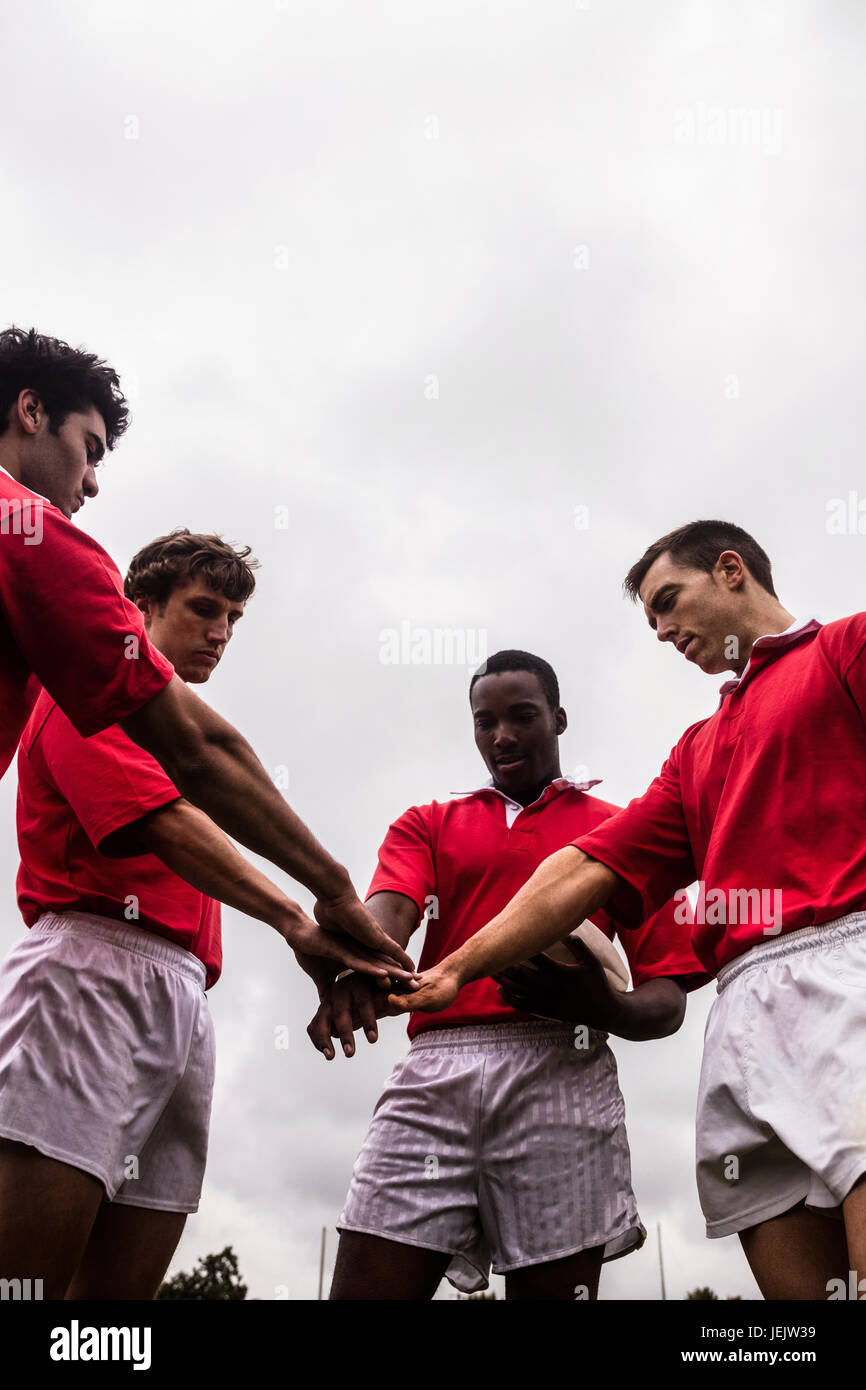 Rugby players putting hands together Stock Photo - Alamy