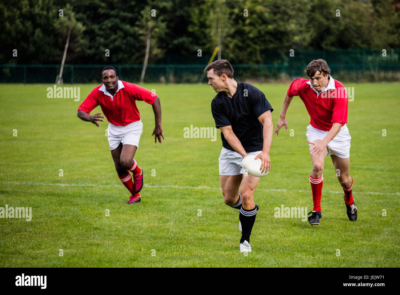 Rugby players running during game Stock Photo - Alamy