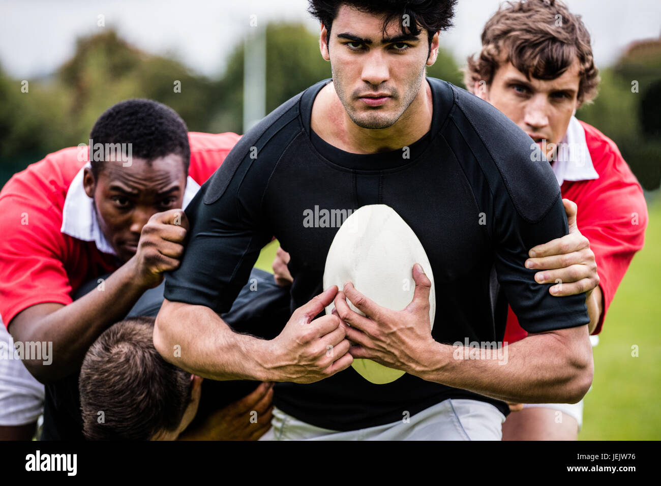 Rugby players tackling during game Stock Photo - Alamy