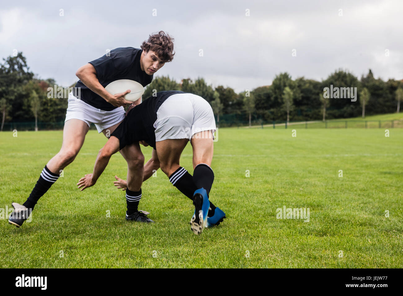Rugby players tackling during game Stock Photo - Alamy
