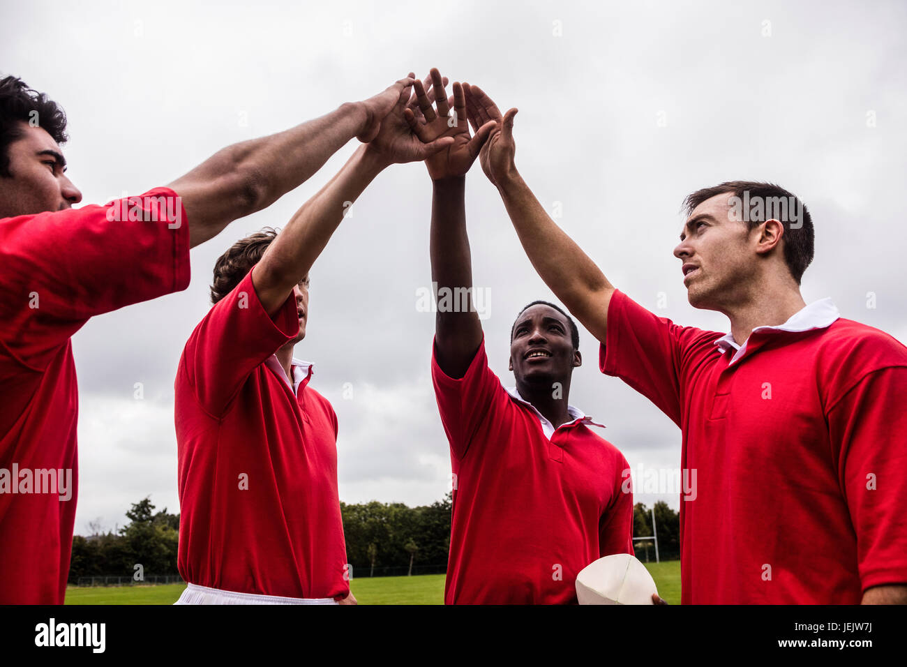 Rugby players putting hands together Stock Photo - Alamy
