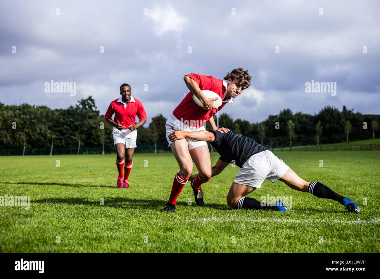 Rugby players tackling during game Stock Photo - Alamy