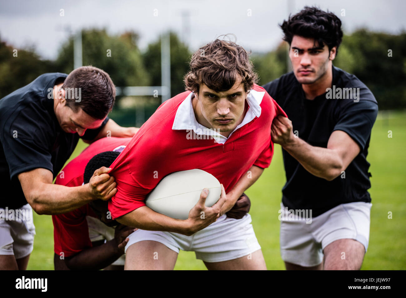 Rugby players tackling during game Stock Photo - Alamy