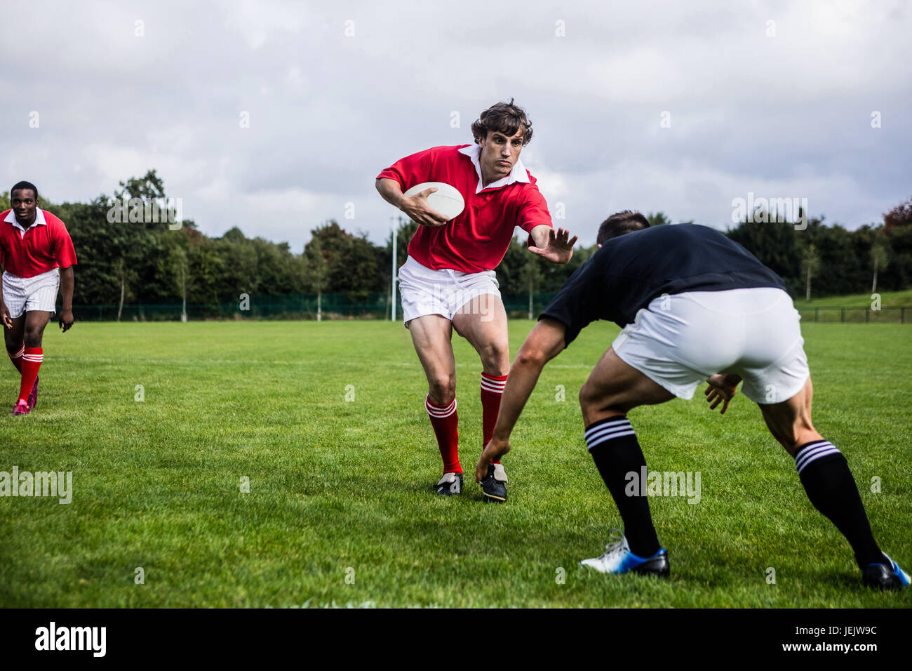 Rugby players tackling during game Stock Photo - Alamy