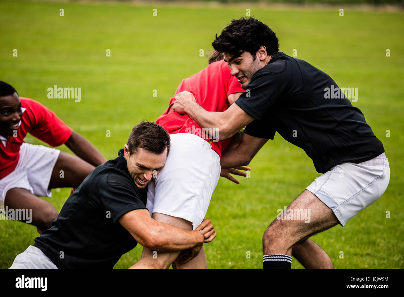 Rugby players tackling during game Stock Photo - Alamy