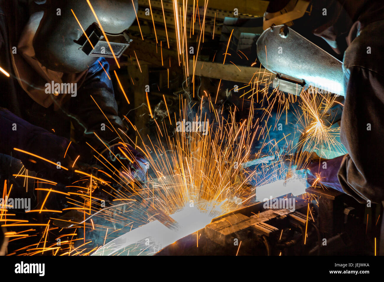 Welders team welding automotive part in assembly line Stock Photo - Alamy