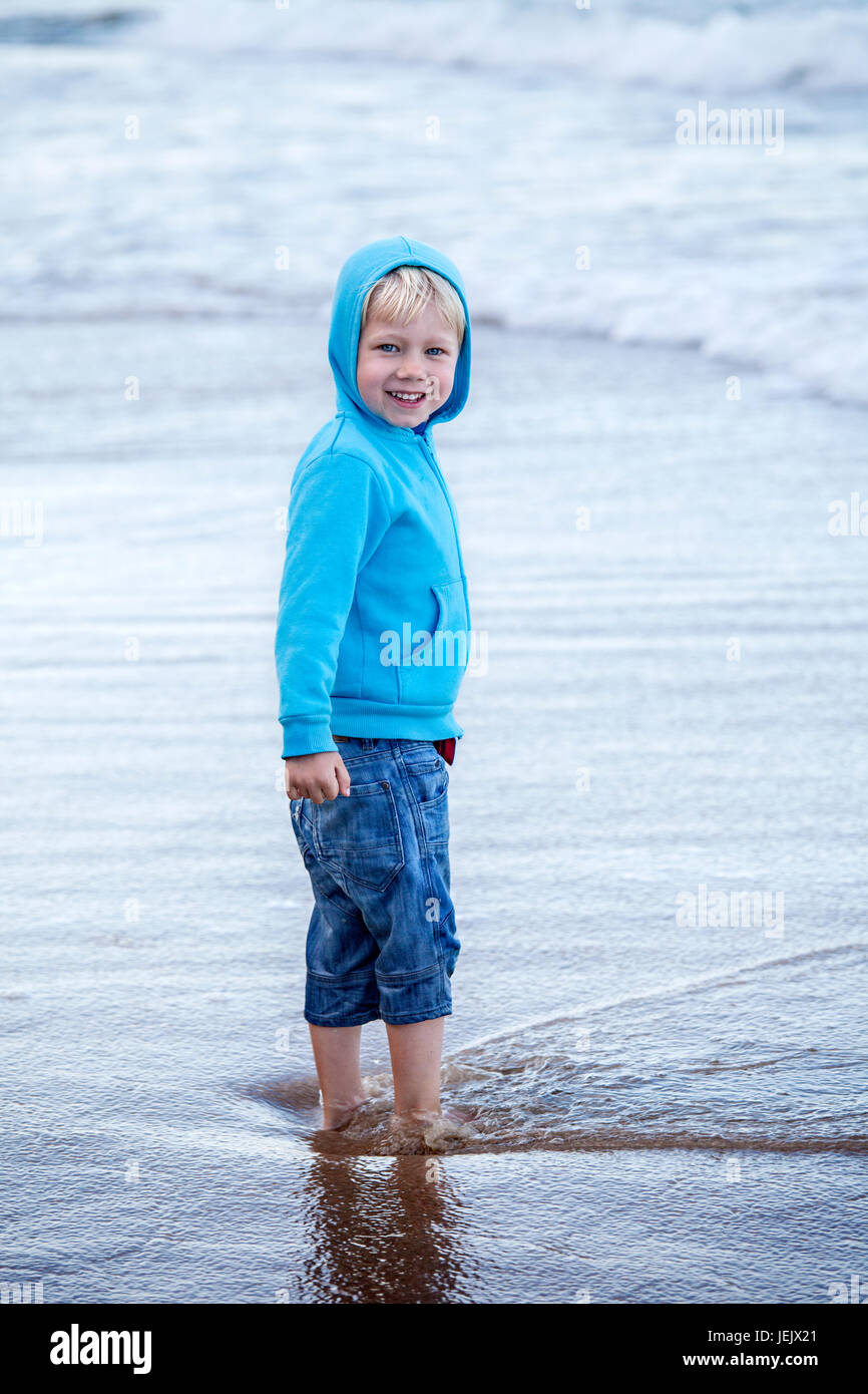 Boy wearing hoodie on beach Stock Photo - Alamy
