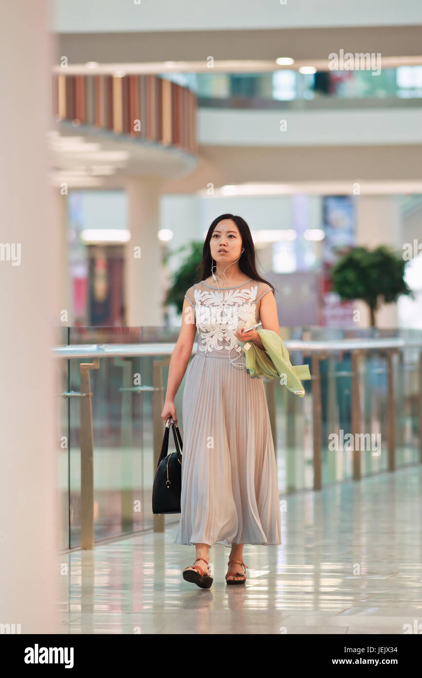 BEIJING-AUGUST 19, 2015. Classy woman shopping Livat mega mall. Owned ...