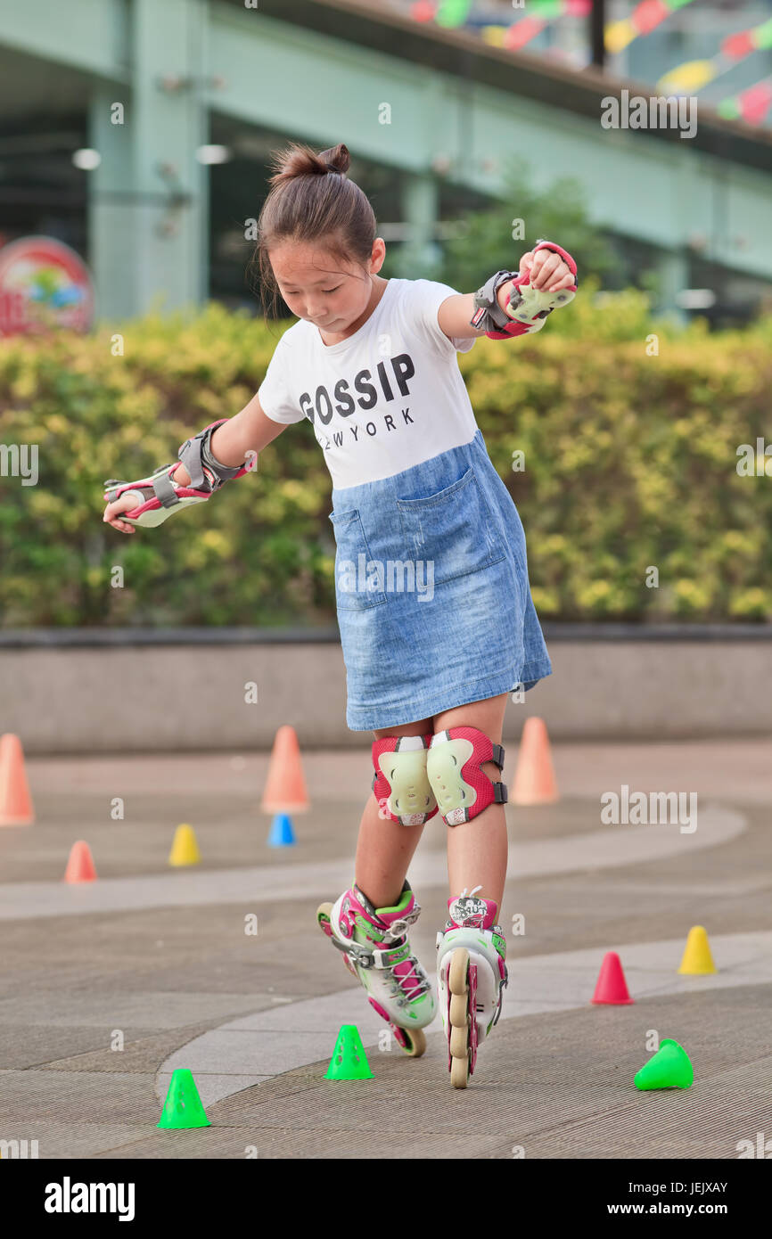 BEIJING-JULY 24, 2015. Girl practicing inline skating. Although Ping ...