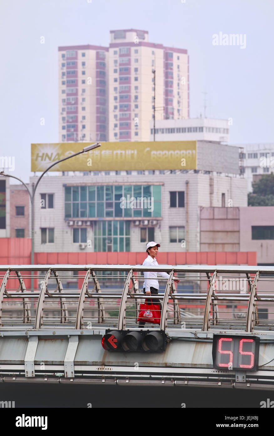 BEIJING-JULY 27, 2015. People on a pedestrian bridge. Beijing has ...
