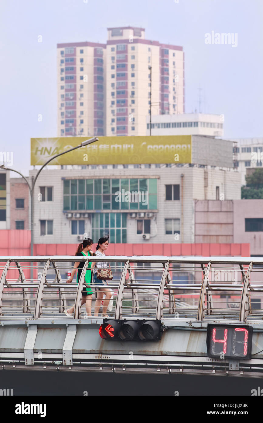 BEIJING-JULY 27, 2015. People on a pedestrian bridge. Beijing has ...