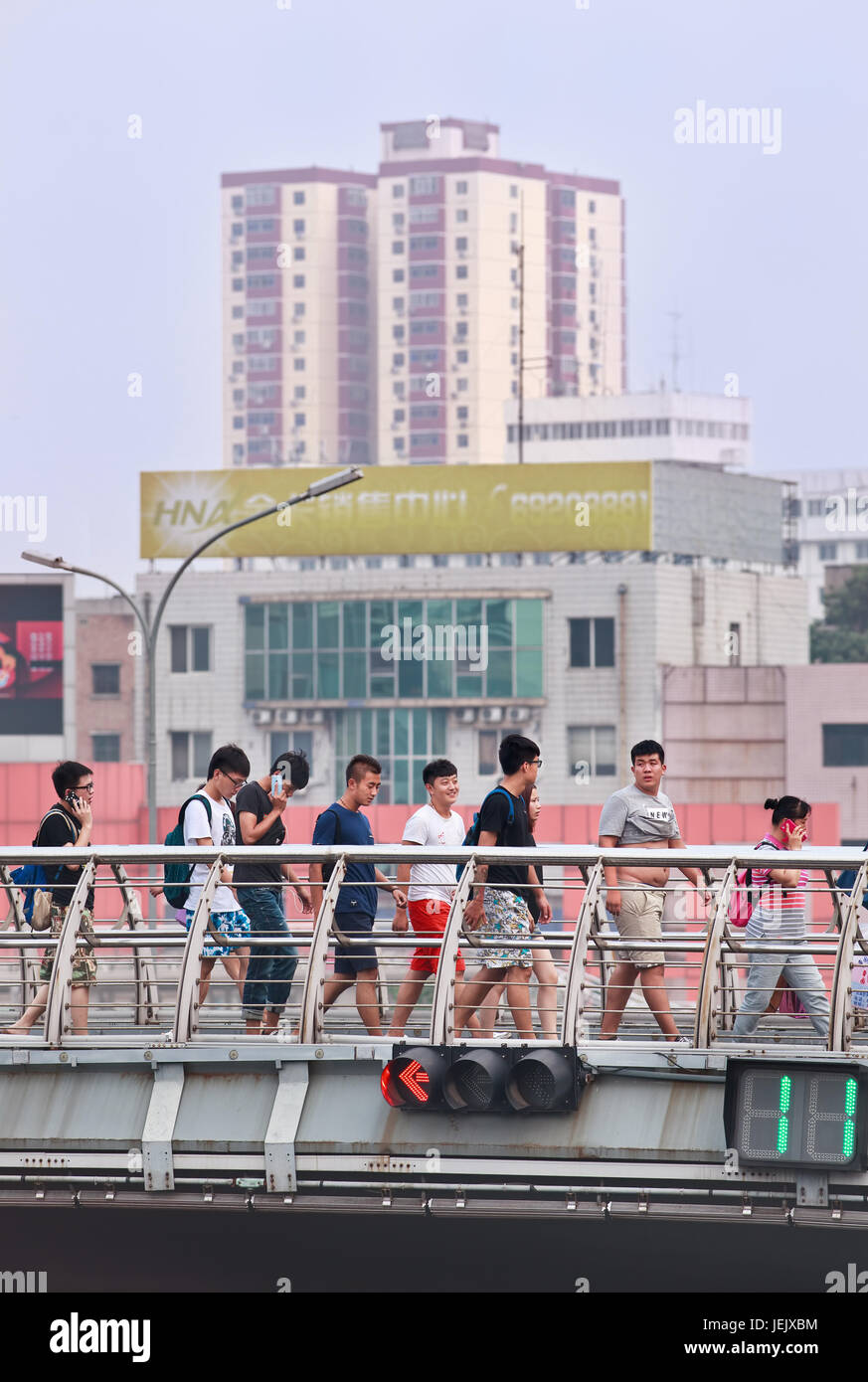 BEIJING-JULY 27, 2015. People on a pedestrian bridge. Beijing has ...
