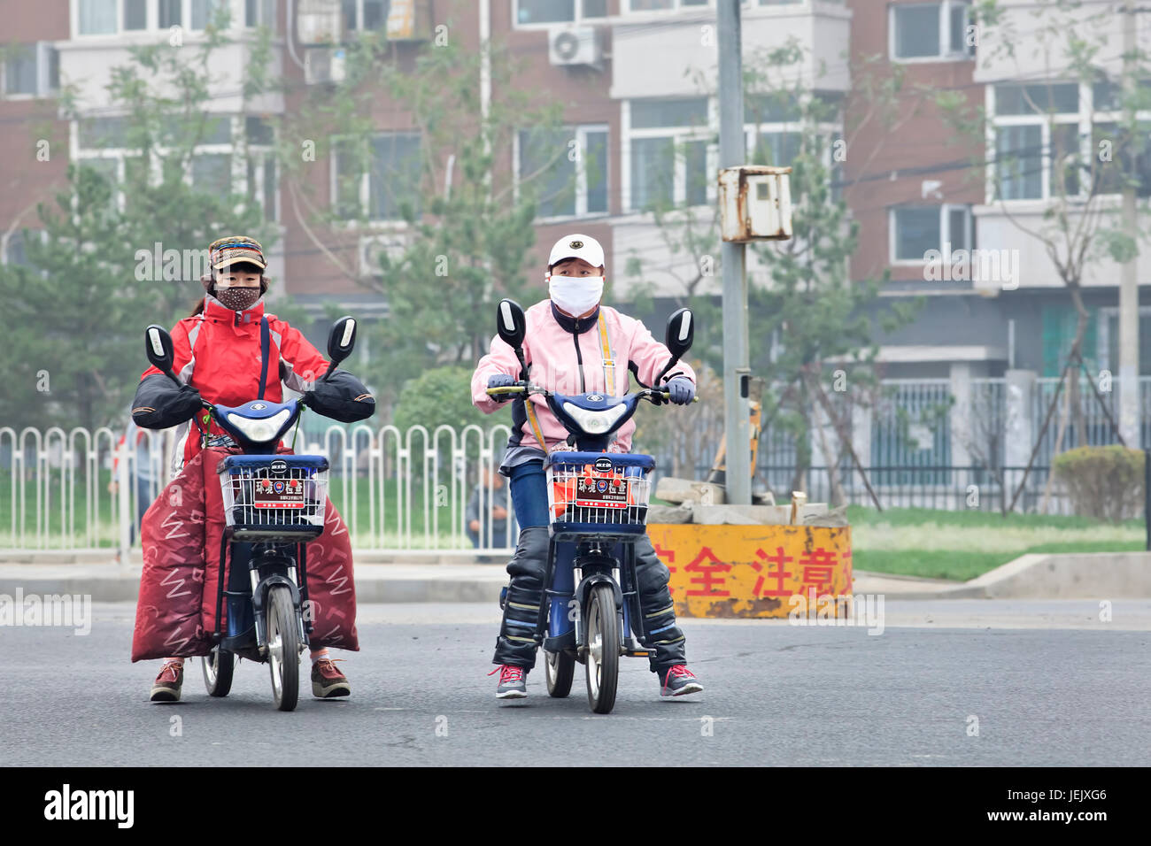 BEIJING- OCT. 6. Citizens on electric bikes take precautions against ...