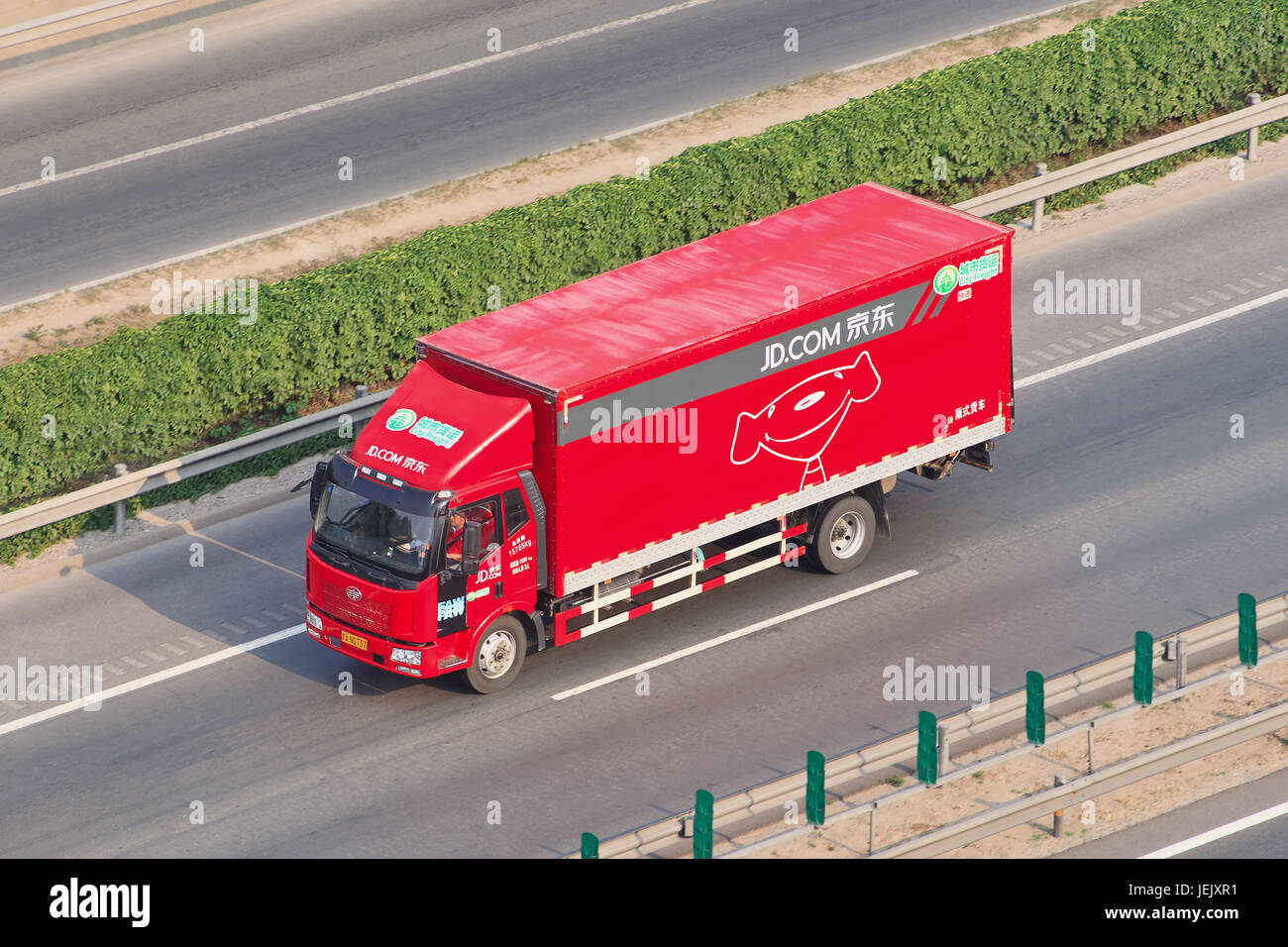 BEIJING-JULY 7, 2015. JD.Com truck on the expressway. JD.com or ...