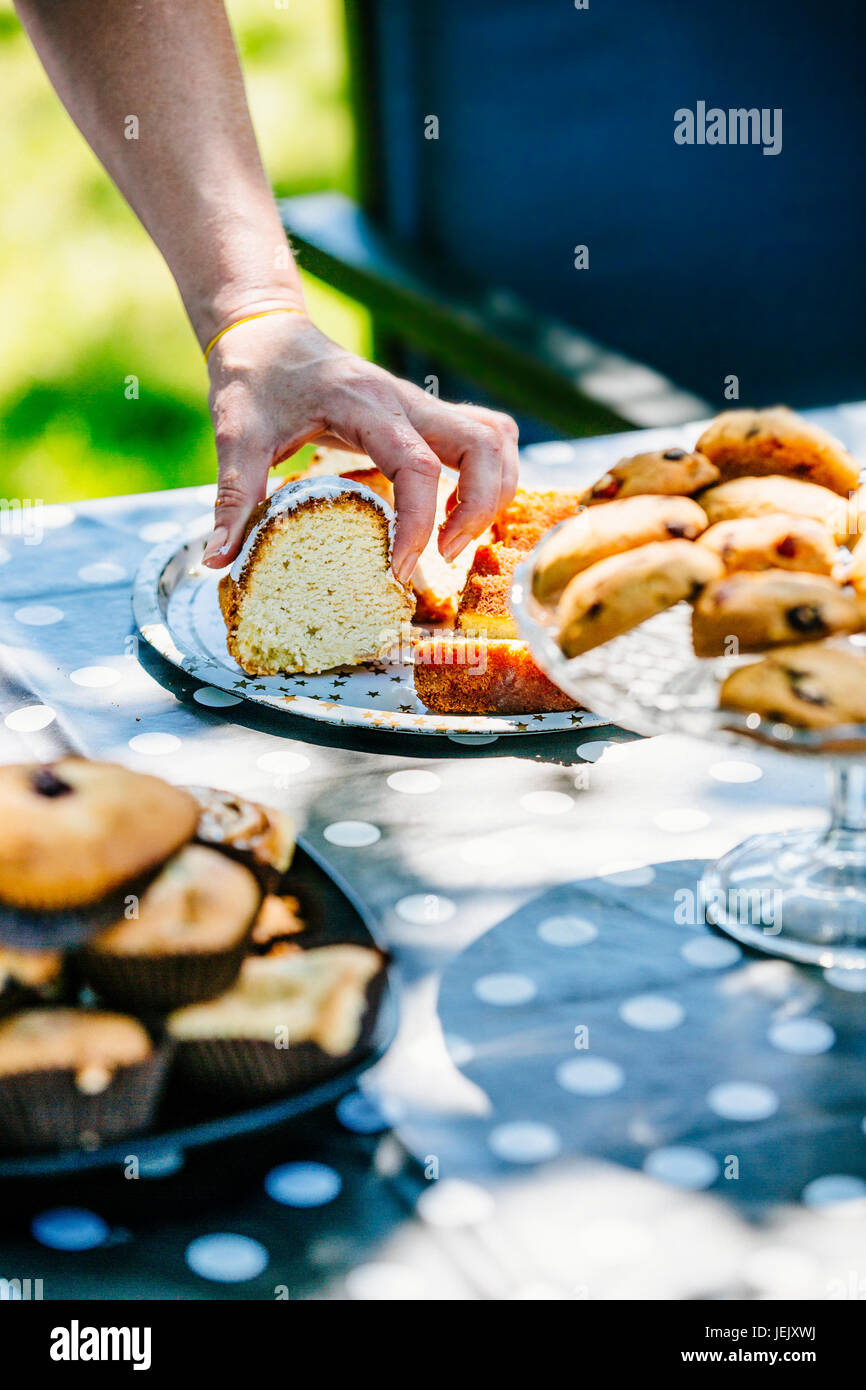 Hand taking cake Stock Photo - Alamy