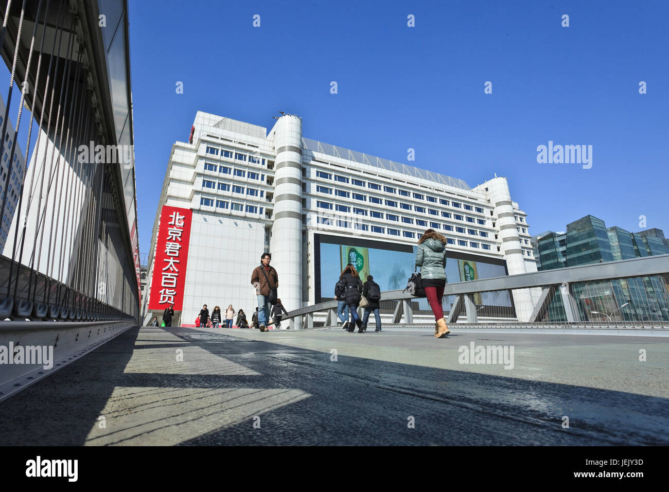 BEIJING – MARCH 12, 2012. People on pedestrian bridge in Beijing Xidan ...