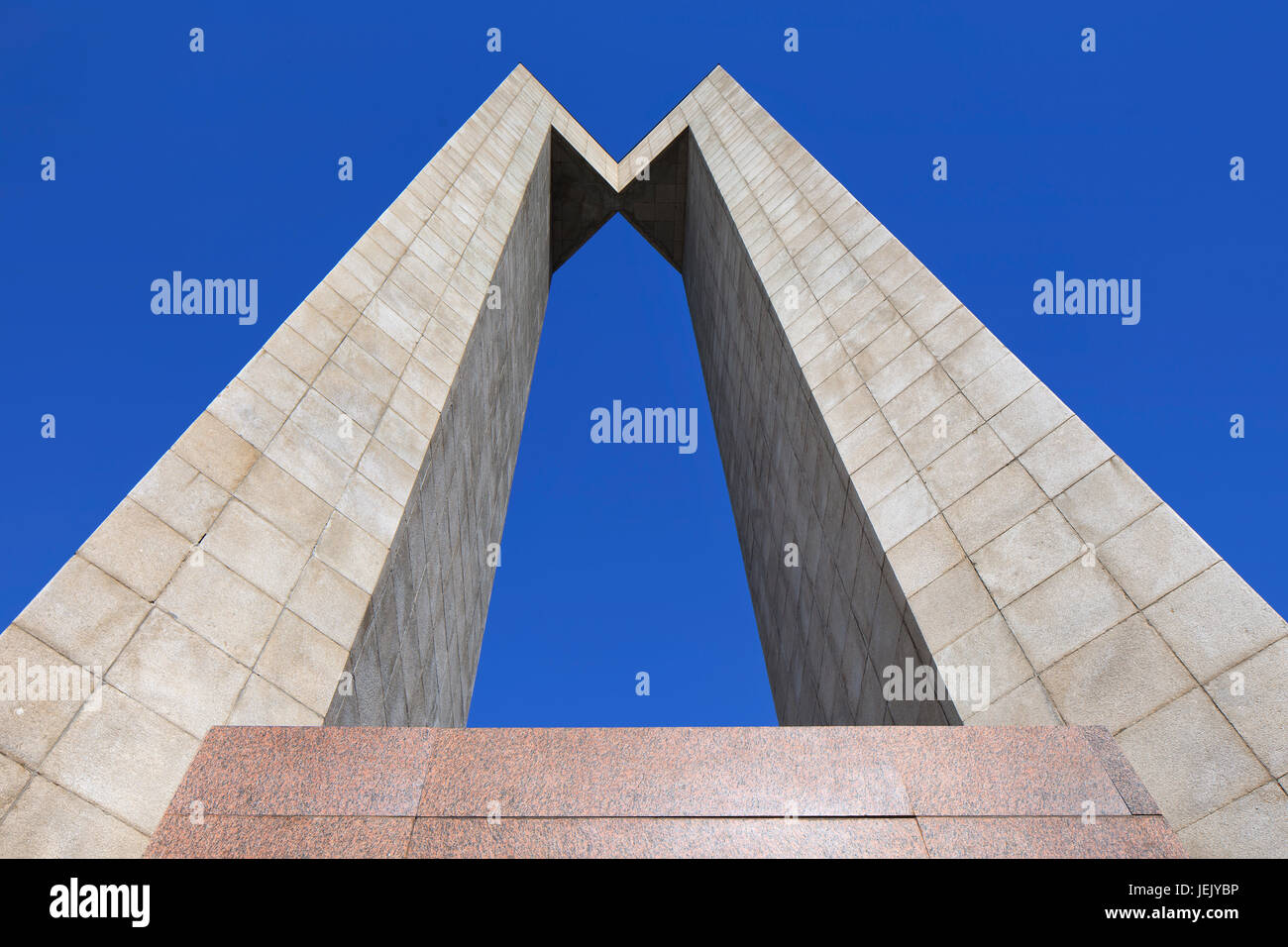 Angular, symmetric shaped tall monument Stock Photo - Alamy