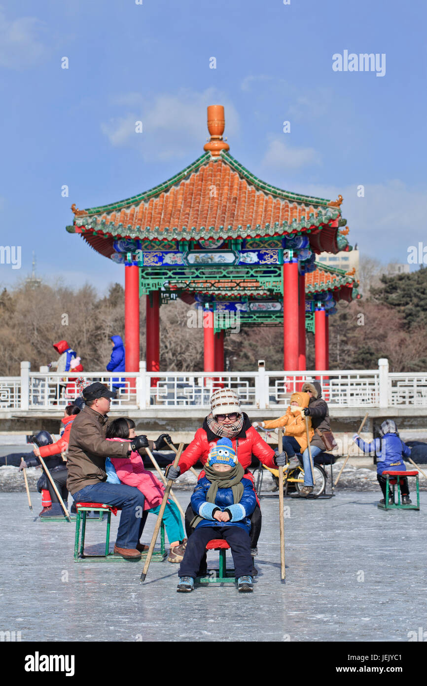 CHANGCHUN – FEB. 4, 2014. People have fun on the ice in Nanhu Park ...